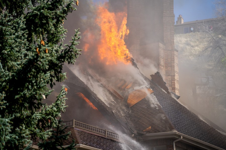 Firefighters battle house fire in Sandy, smoke and flames visible