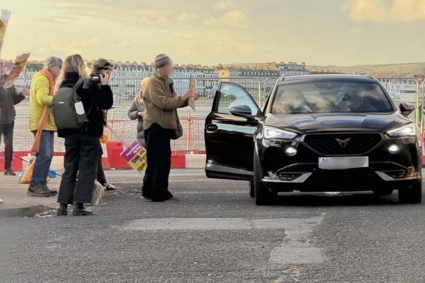 Police step in during clash at protest after 'car struck with sign'