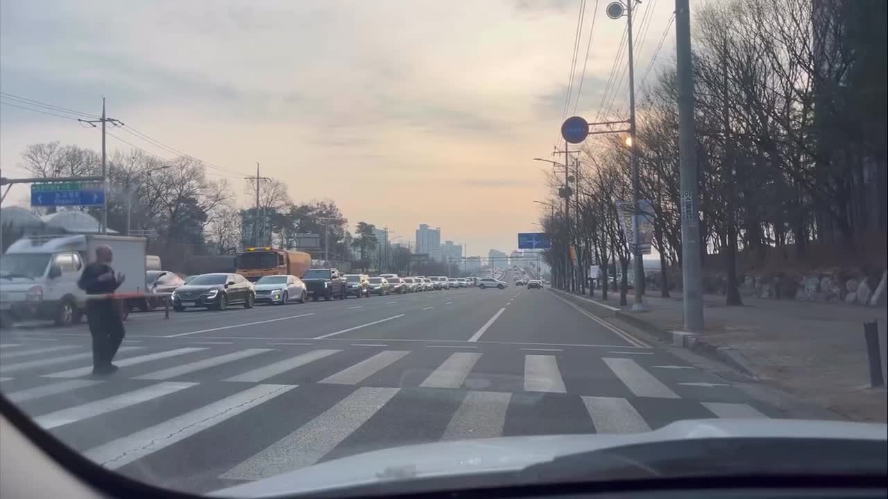 Amusing moment elderly man hula hoops while crossing zebra lane