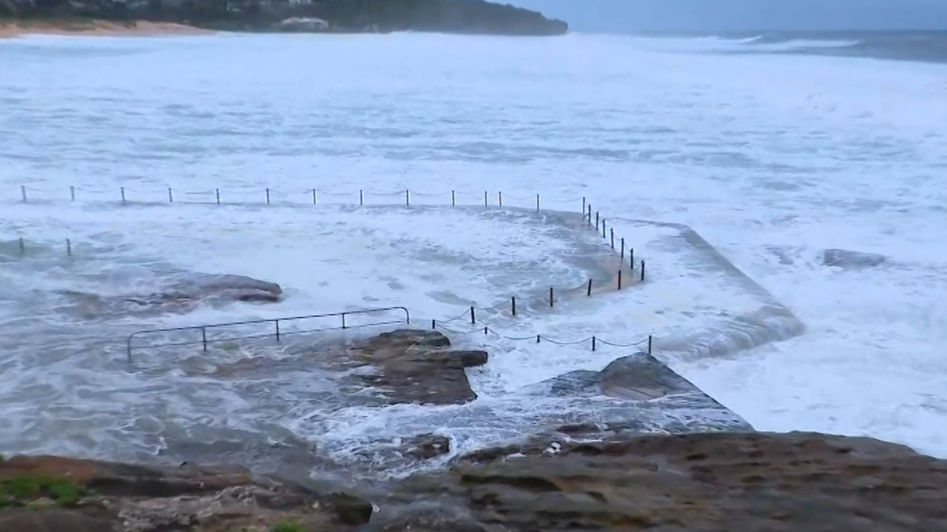 Daring rock fisher rescue as huge waves batter Sydney's beaches