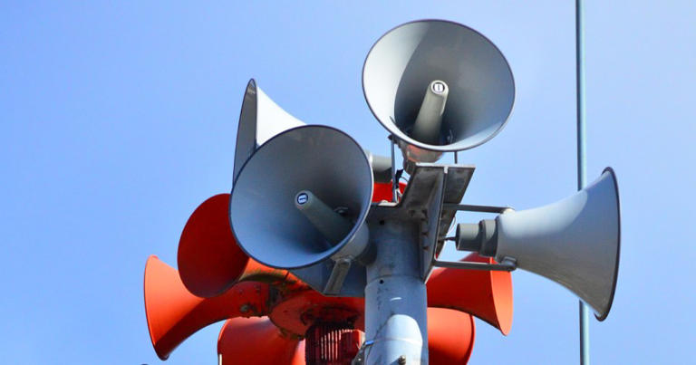 Why did warning sirens go off in Riley County on Tuesday?