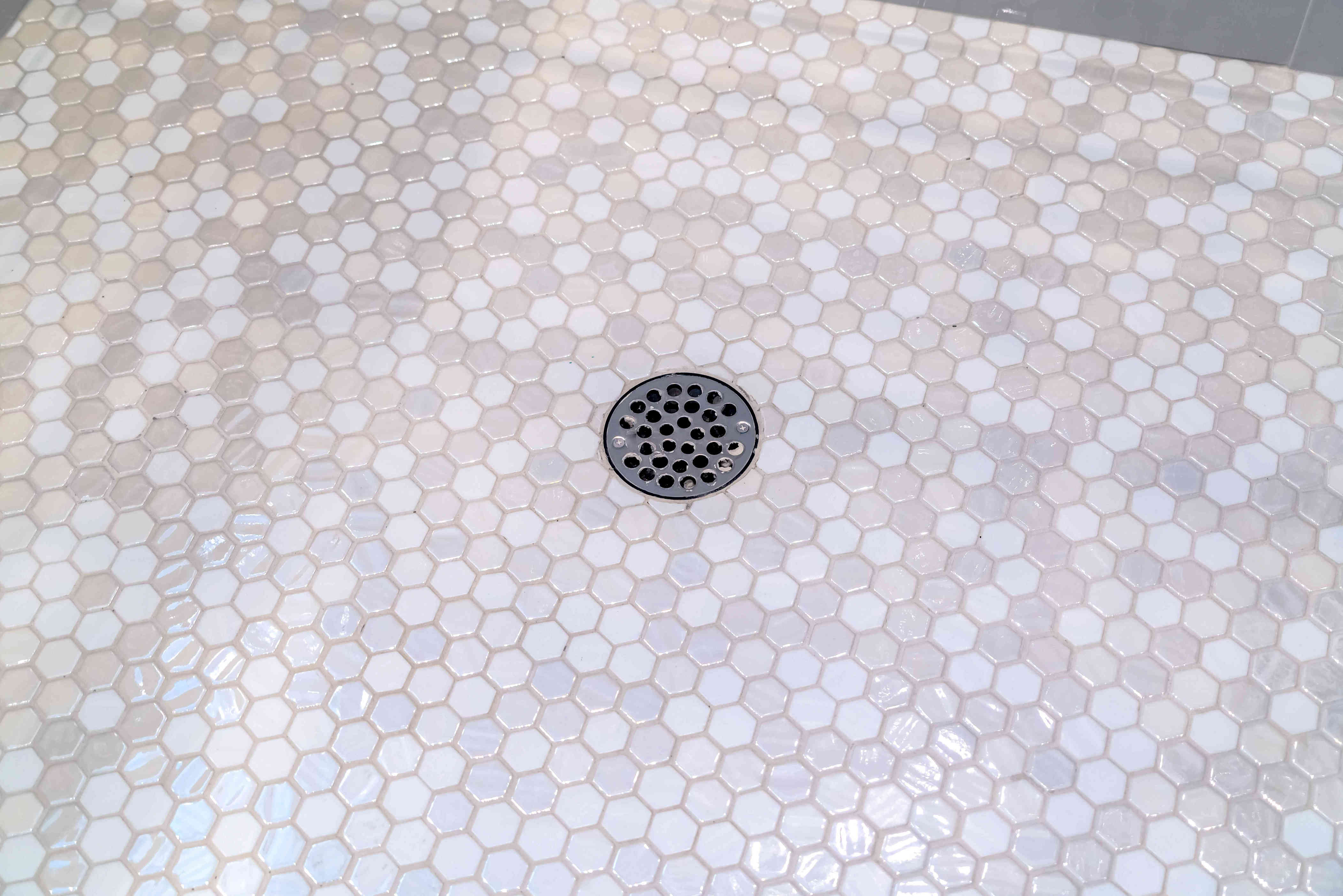 How to clean a shower drain before hair and buildup cause a clog