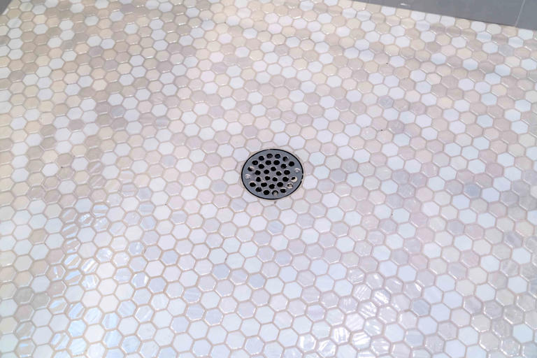 How to clean a shower drain before hair and buildup cause a clog