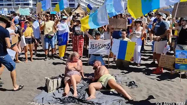 Hundreds of anti-tourist protesters storm Tenerife beach Hundreds of anti-tourist protesters storm Tenerife beach