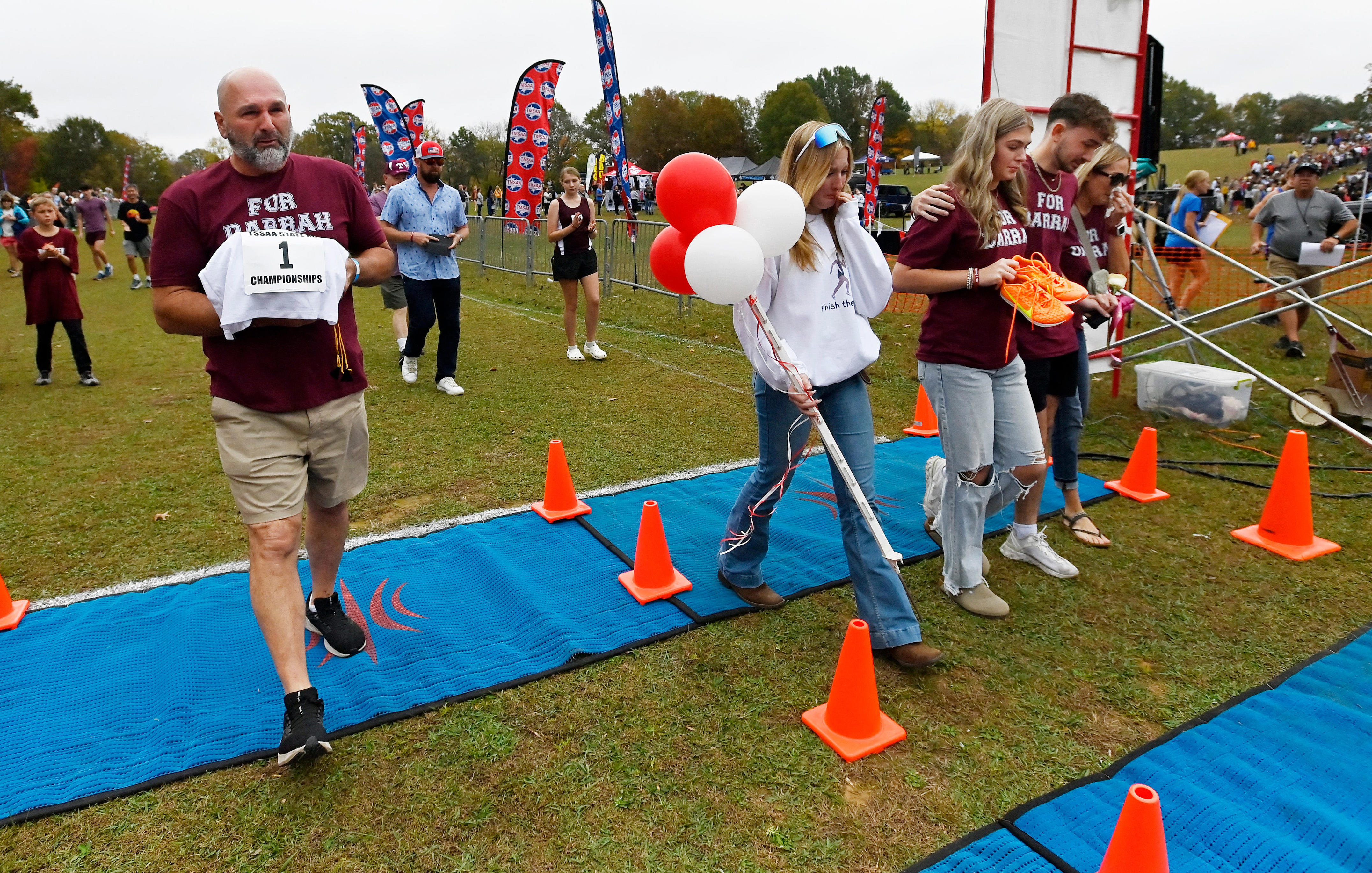 A star athlete died. The family crossed finish line with bib at state ...
