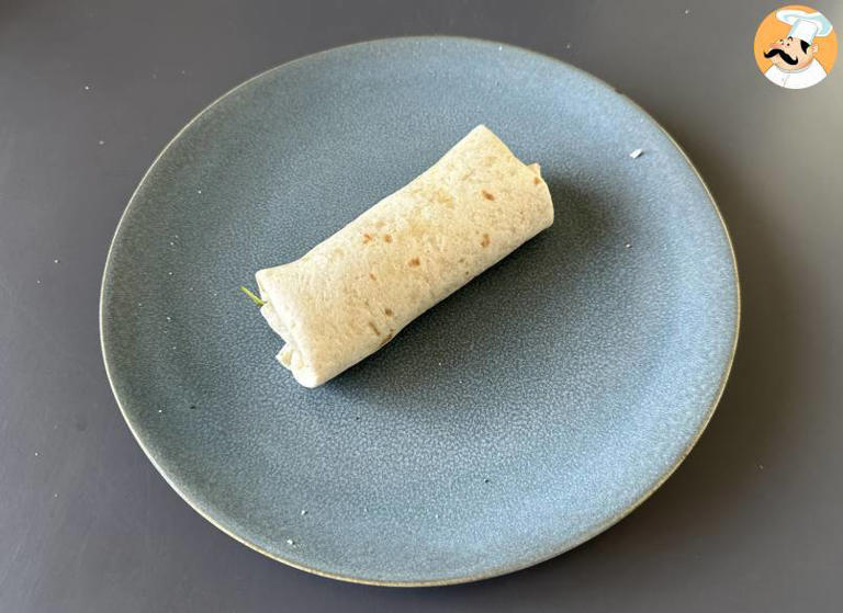 Mediterranean wrap stuffed with hummus, arugula, peppers and feta