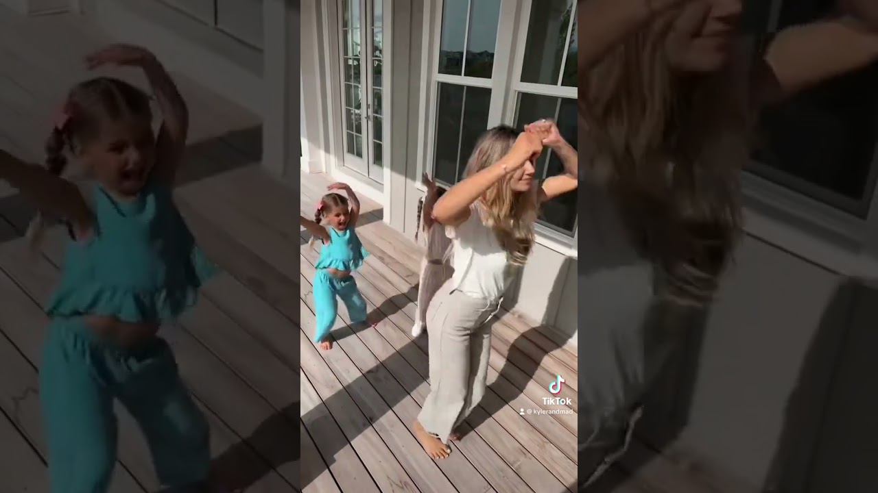 Mother teaches her twin daughters a popular new dance trend