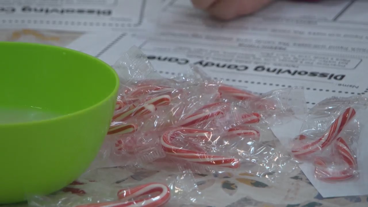 Kids learning magic of science with dancing candy canes