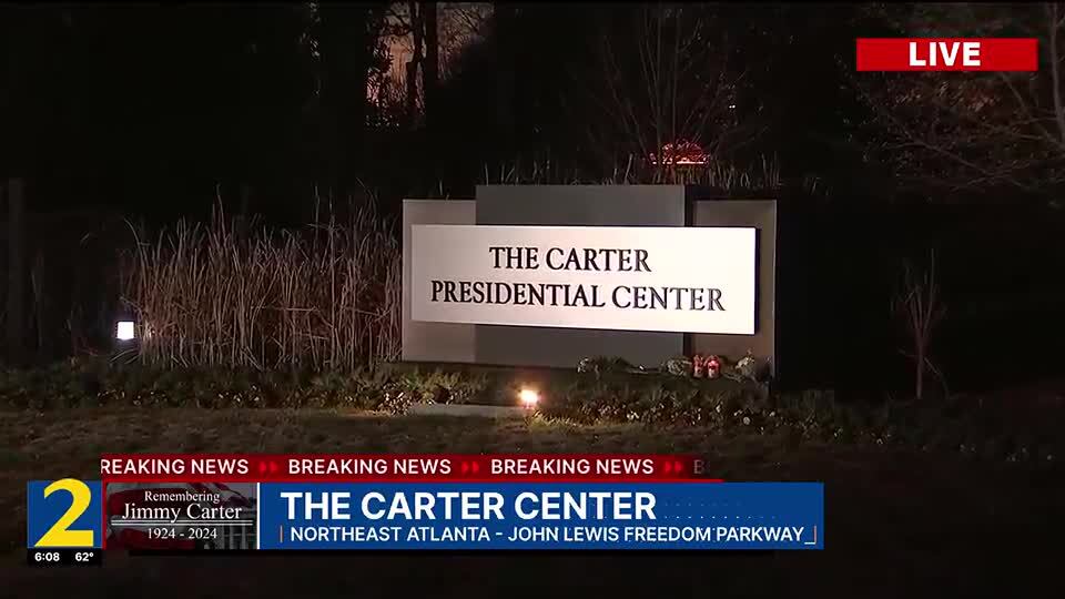 Remembering Jimmy Carter: Flowers placed outside entrance to Carter Center