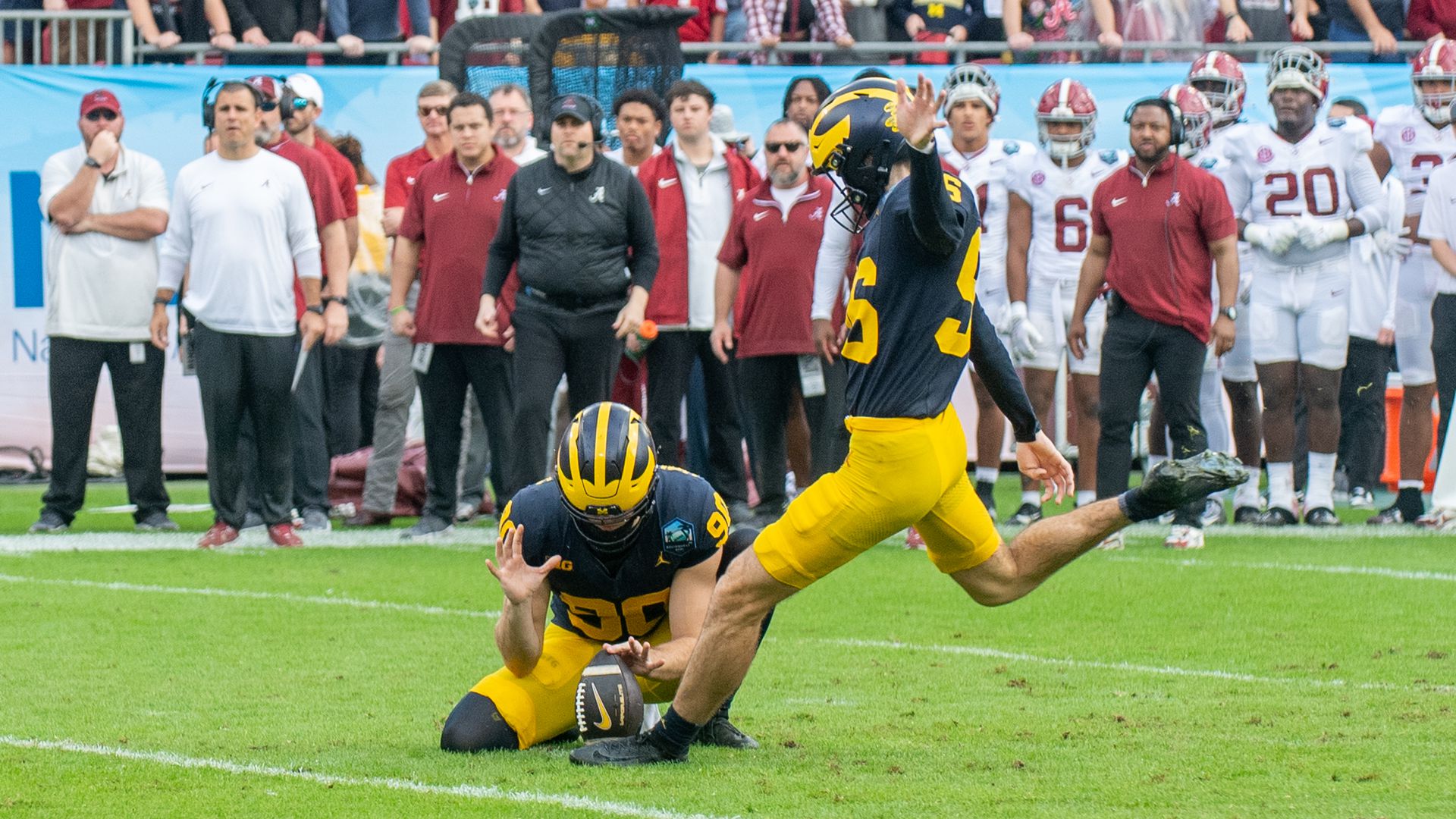 Handing out game balls after Michigan’s upset victory over Alabama