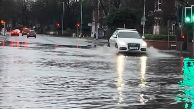 Cars attempt to drive through flooding in Manchester