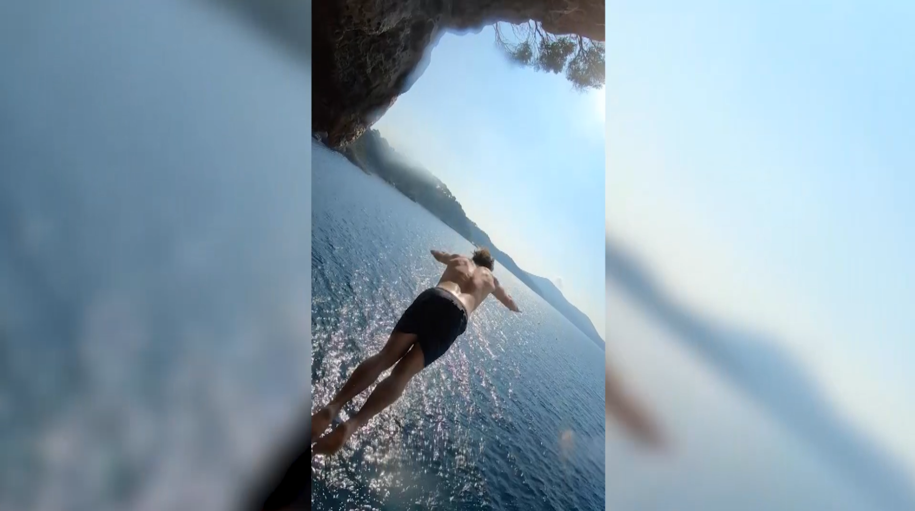 Group Of Daredevil Divers Jump Into Ocean From Cliffs