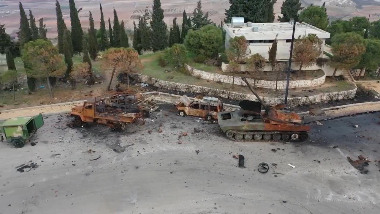 Aftermath of battle in Syrian city of Hama with charred tanks near mosque