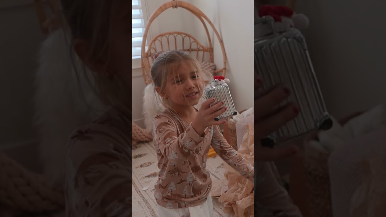 Family works together to decorate a beautiful children's Christmas tree