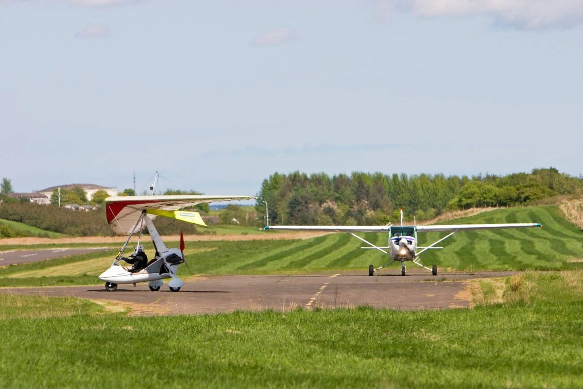 Emergency services at scene after light aircraft crashes near airport Emergency services at scene after light aircraft crashes near airport