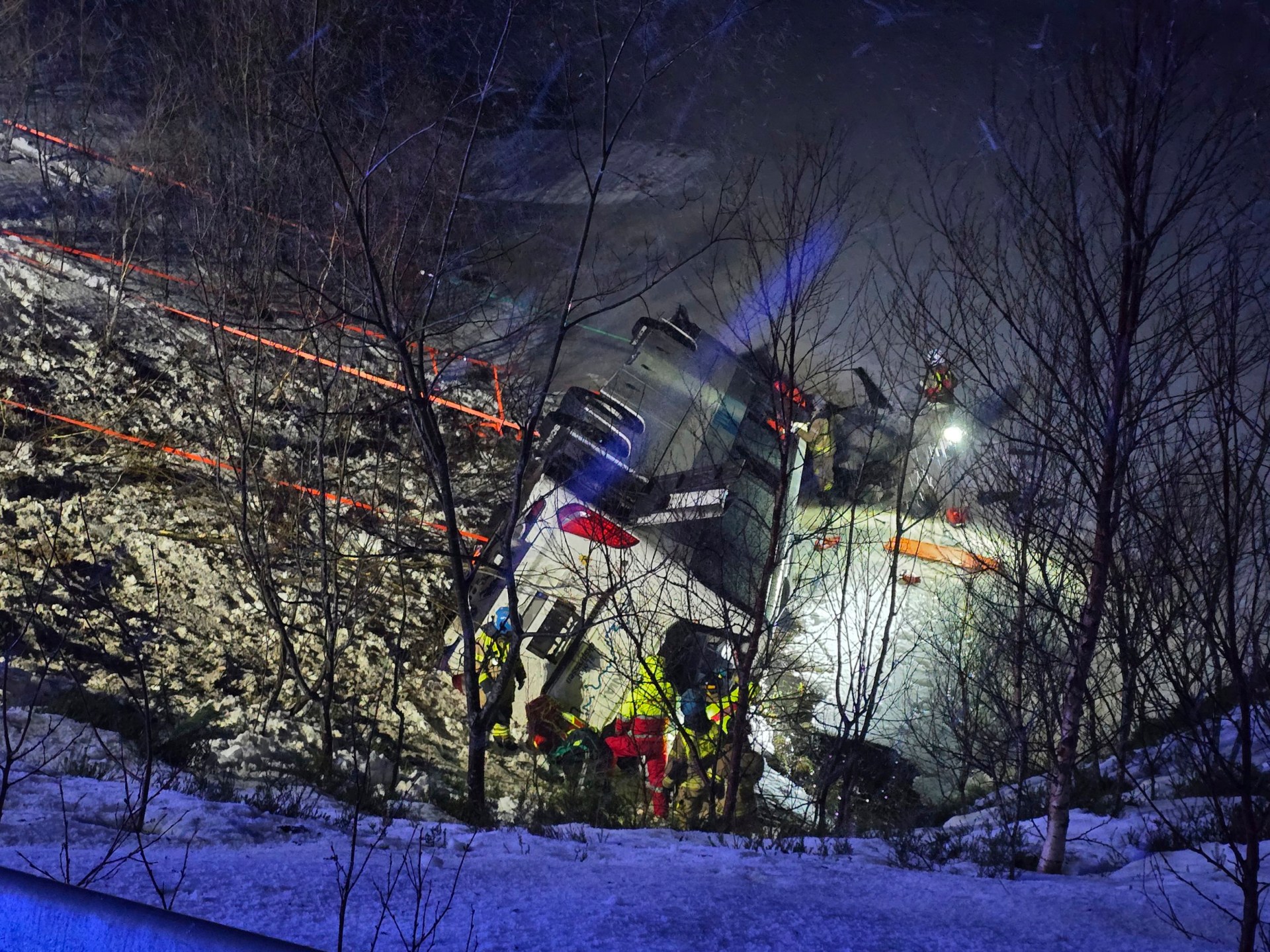 Rescuers work to save bus passengers after crash kills at least three
