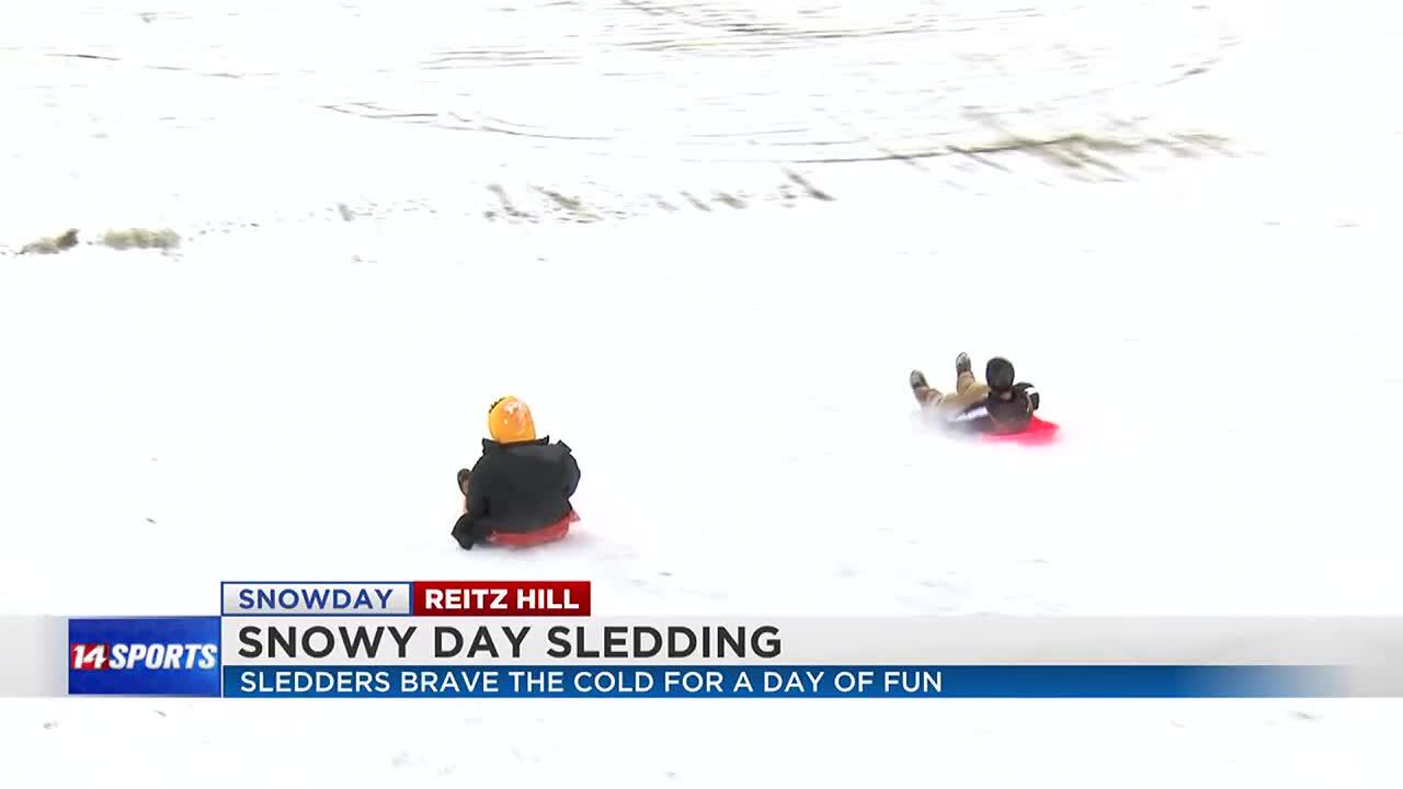 Kids get out and sled down Reitz Hill on first snow day of the year