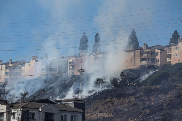 Fire near shopping mall in California threatens homes and forces ...