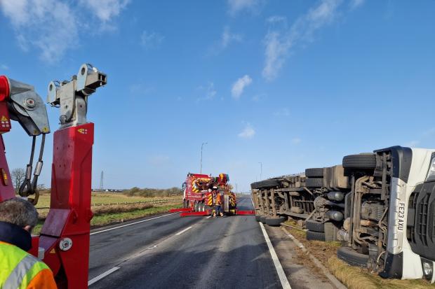 Road closed after lorry tipped over by strong winds