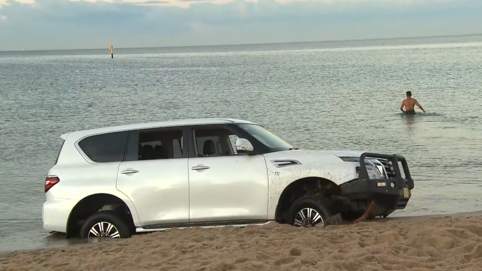 Front-end loader removes bogged car from Melbourne beach