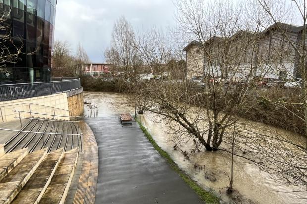 River bursts its banks in town centre amid multiple flood warnings