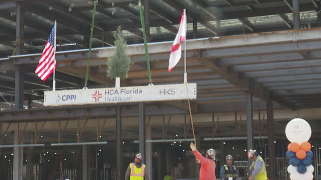 Gainesville residents and HCA leaders sign final I-beam placed in ...