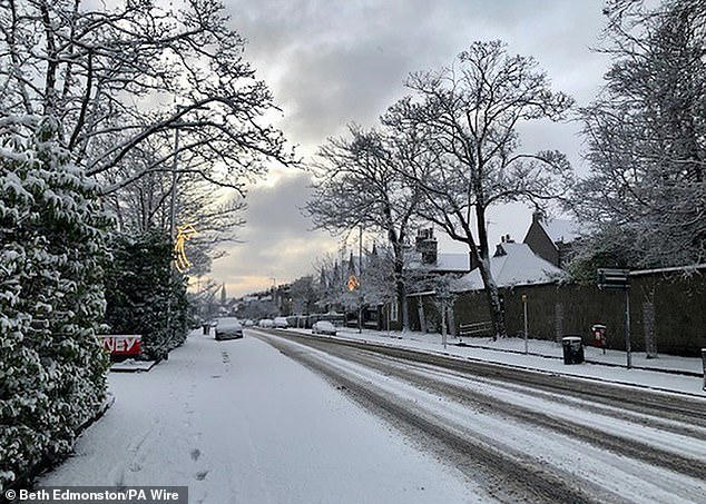 Cars skid in rush hour blizzards as Met Office issue weather warnings