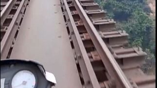 Viral Video: Jharkhand Rider's Reckless Stunt on Railway Track Puts ...