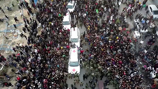 Crowds surround Red Cross trucks in Gaza during hostage release