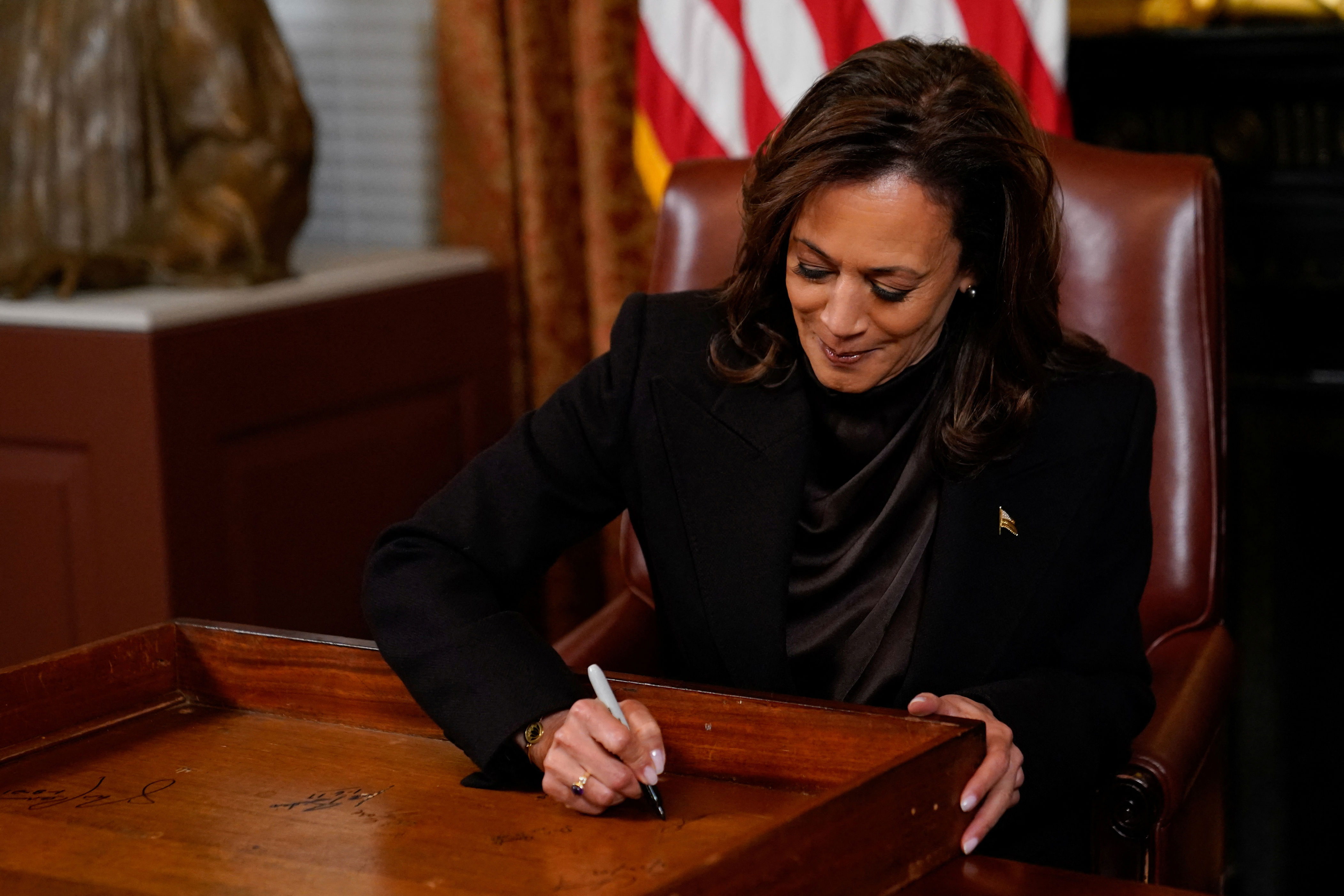 Kamala Harris says she won't ‘go quietly into the night’ as she signs ...