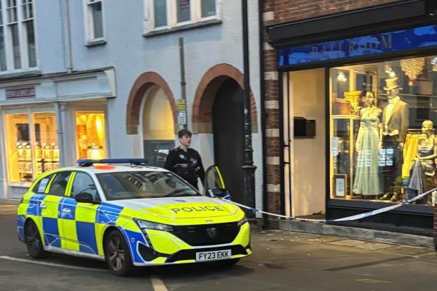 Police tape off shop by busy roundabout as cordon in place Police tape off shop by busy roundabout as cordon in place