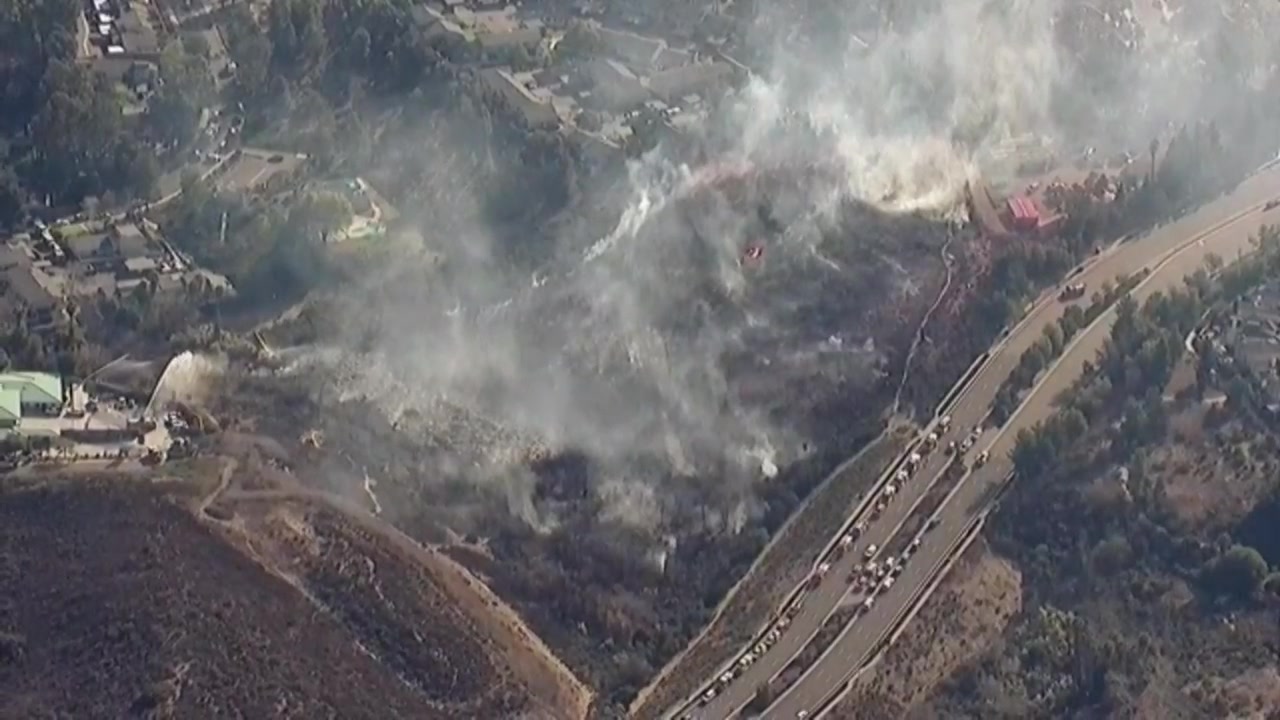 Fire crews battle brush fire near homes in Poway