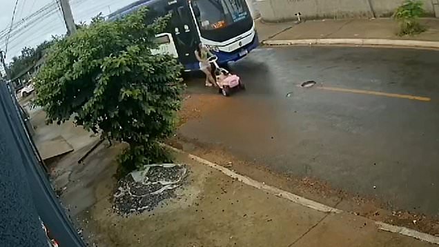 Shocking moment mother walking her pram is almost run over by bus