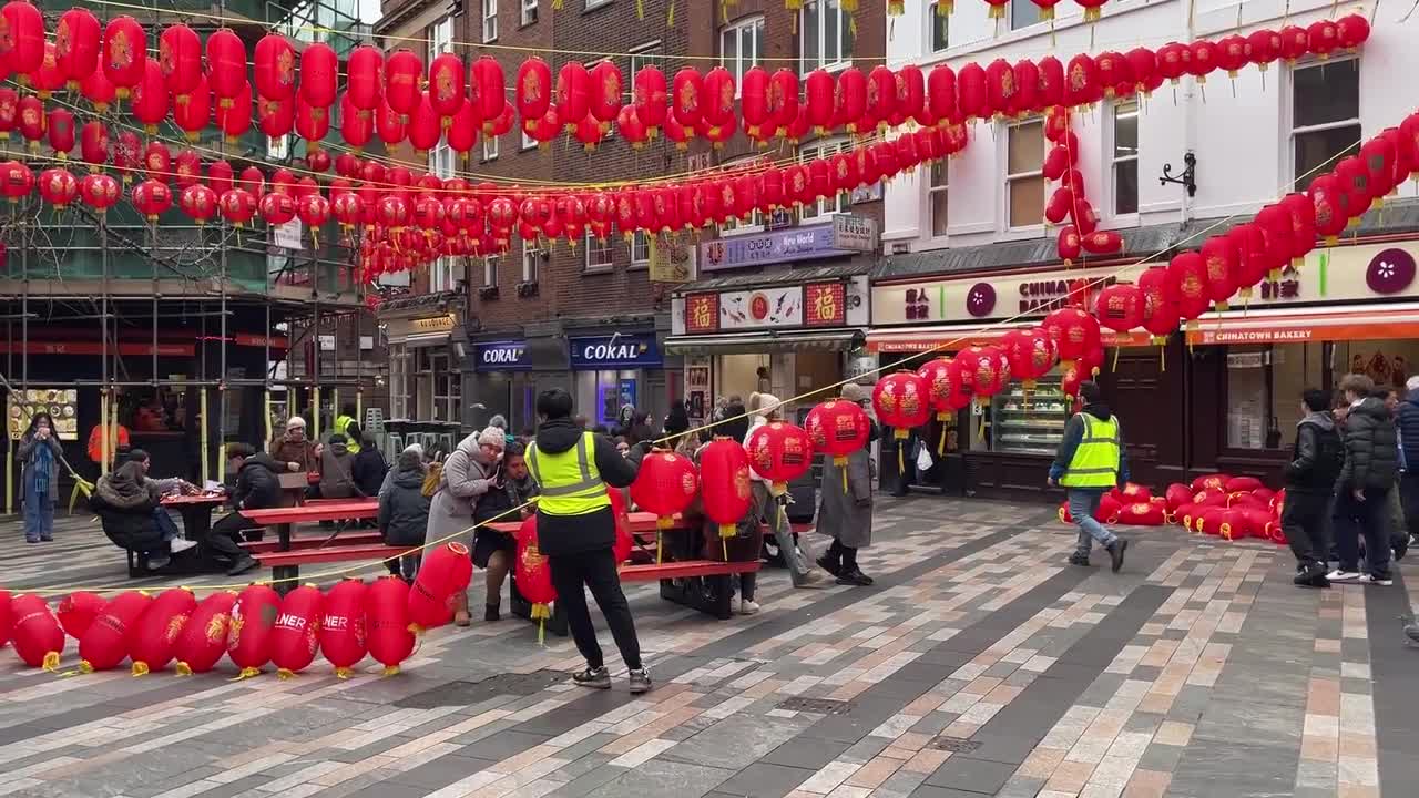 Workers install new red lanterns in London's Chinatown, ahead of ...