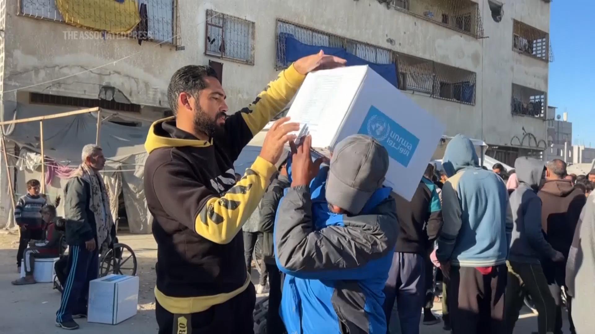 Dozens of Palestinians gather outside aid distribution center as Gaza ...