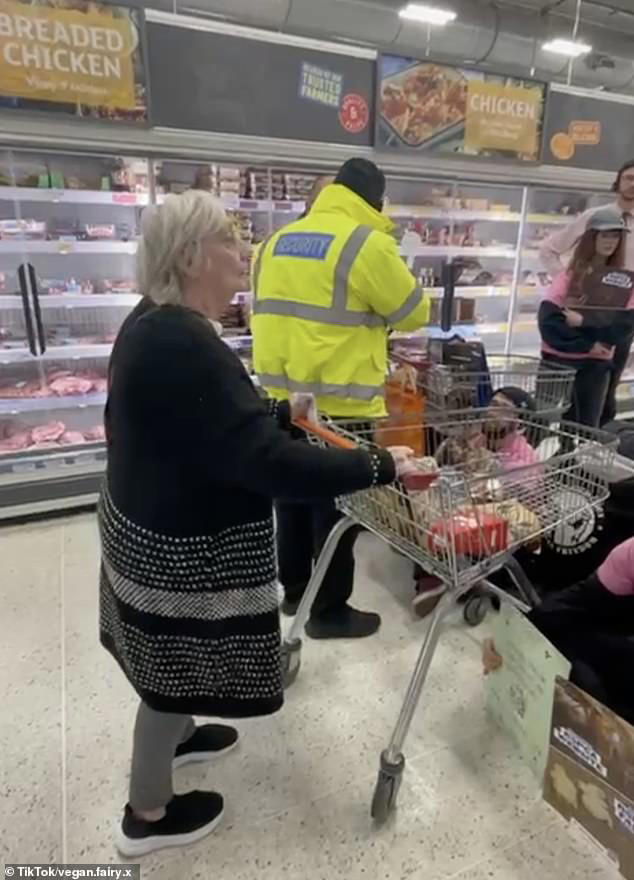 Moment angry shoppers try to barge Animal Rising activists out of way