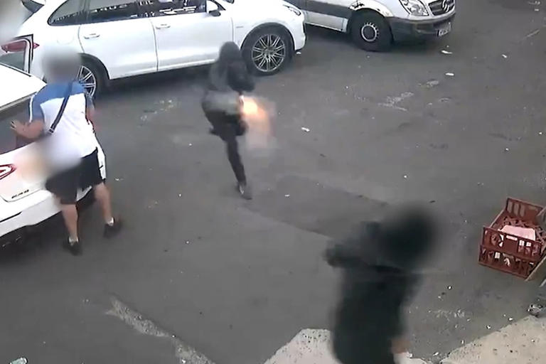 Armed police arrest gunman after broad daylight car park shootout Armed police arrest gunman after broad daylight car park shootout