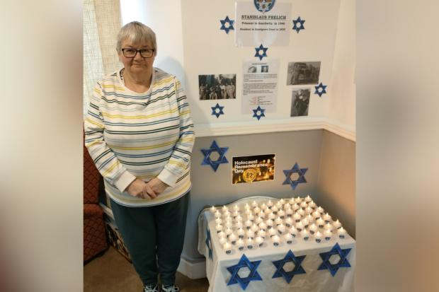 Residents light candles to remember 80 years since Auschwitz's liberation
