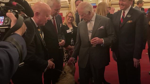 King meets new MPs at Buckingham Palace and gets friendly with a dog
