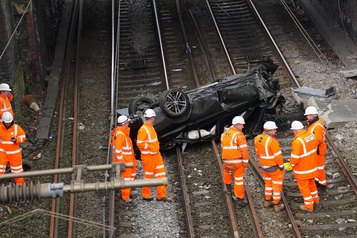 Major train line blocked after car crashed on to tracks