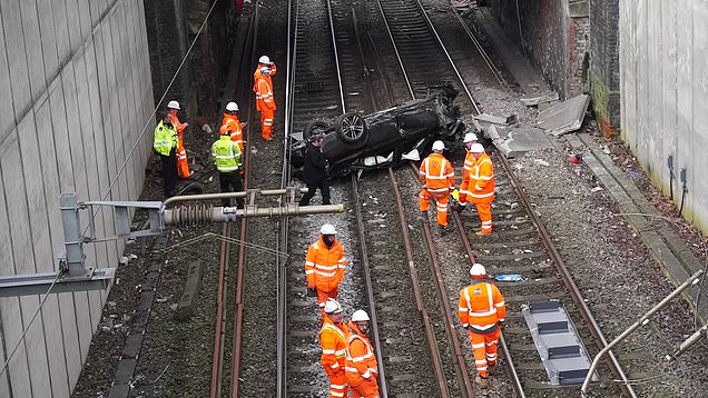 Major train line blocked after car crashed on to tracks