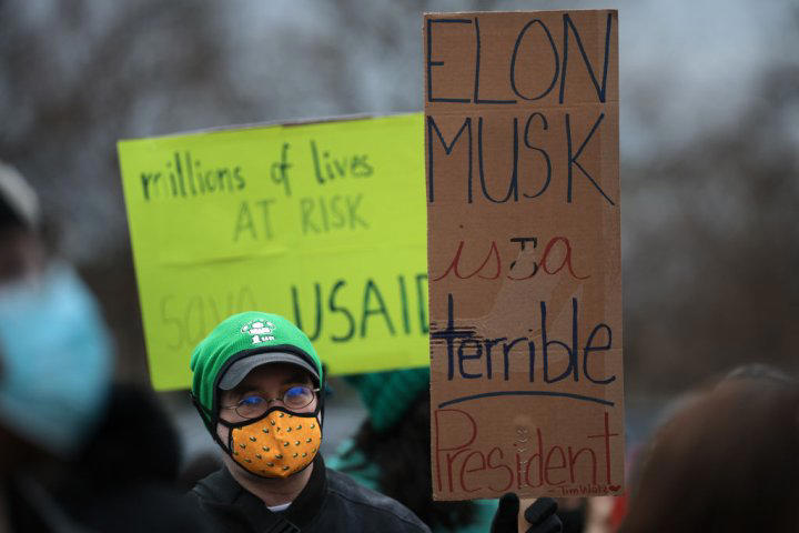 Angry protesters with scathing signs take on Donald Trump, Elon Musk in ...
