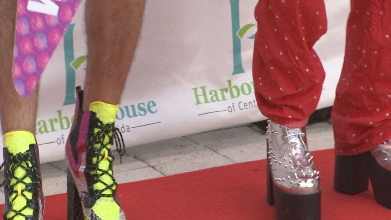 12th annual Walk a Mile in Her Shoes, Men standing against domestic ...