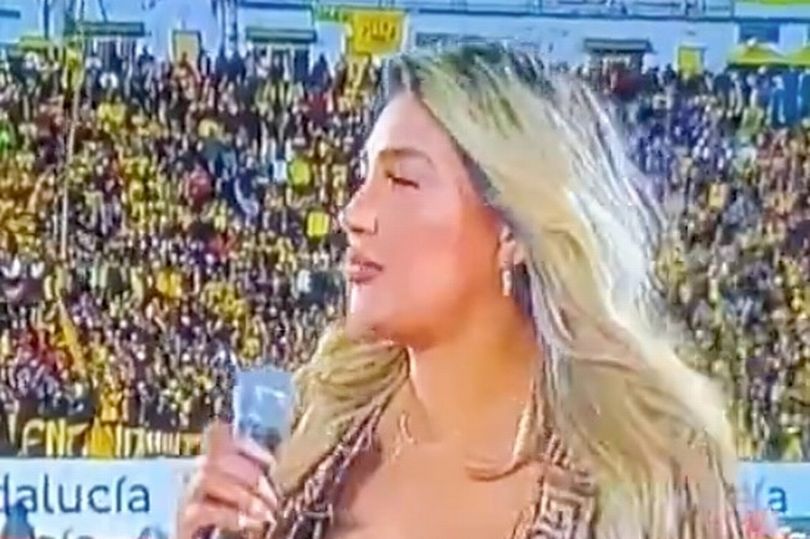 Glam football reporter checks she's not had a wardrobe malfunction in ...