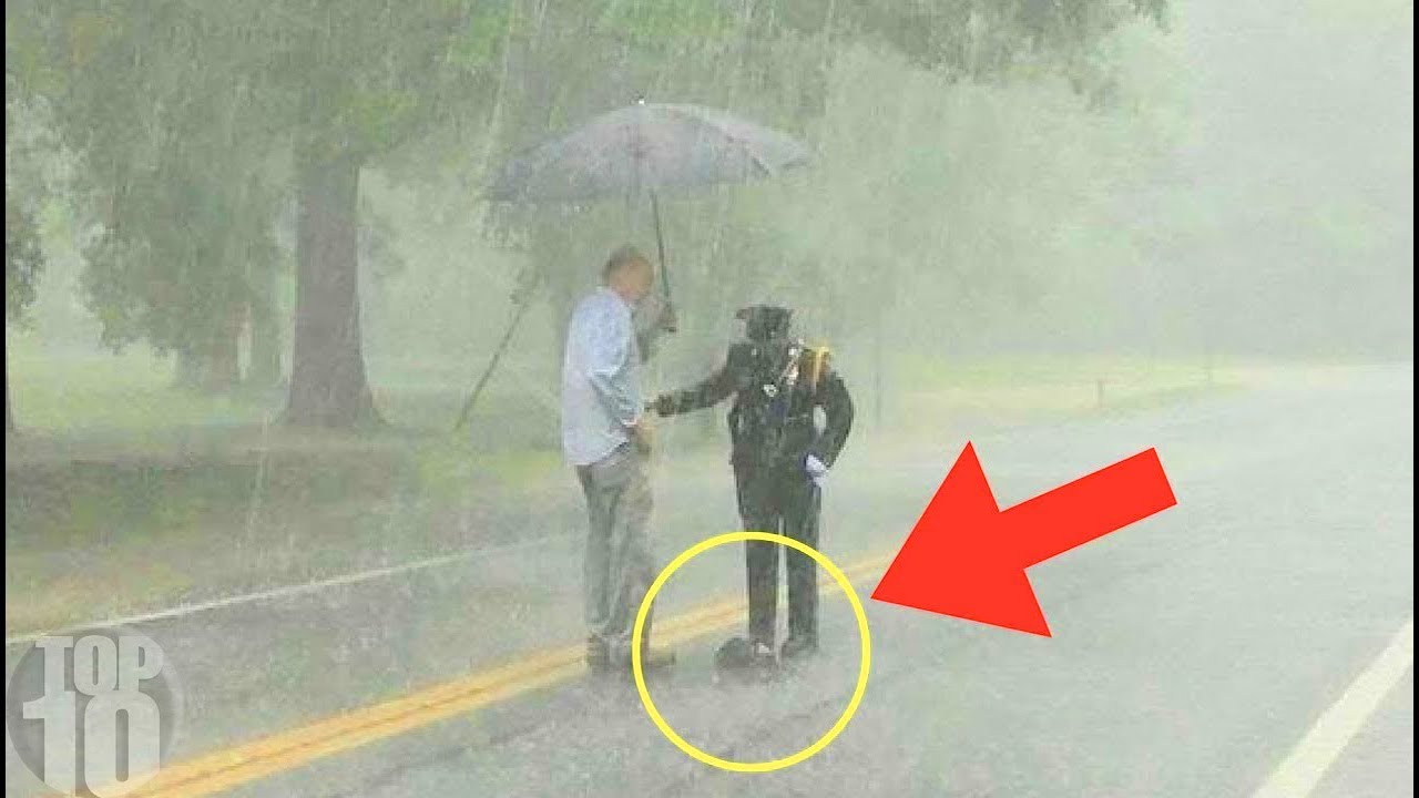 Couple Sees Weird Cop Standing In Rain, Then Realizes What She's Doing