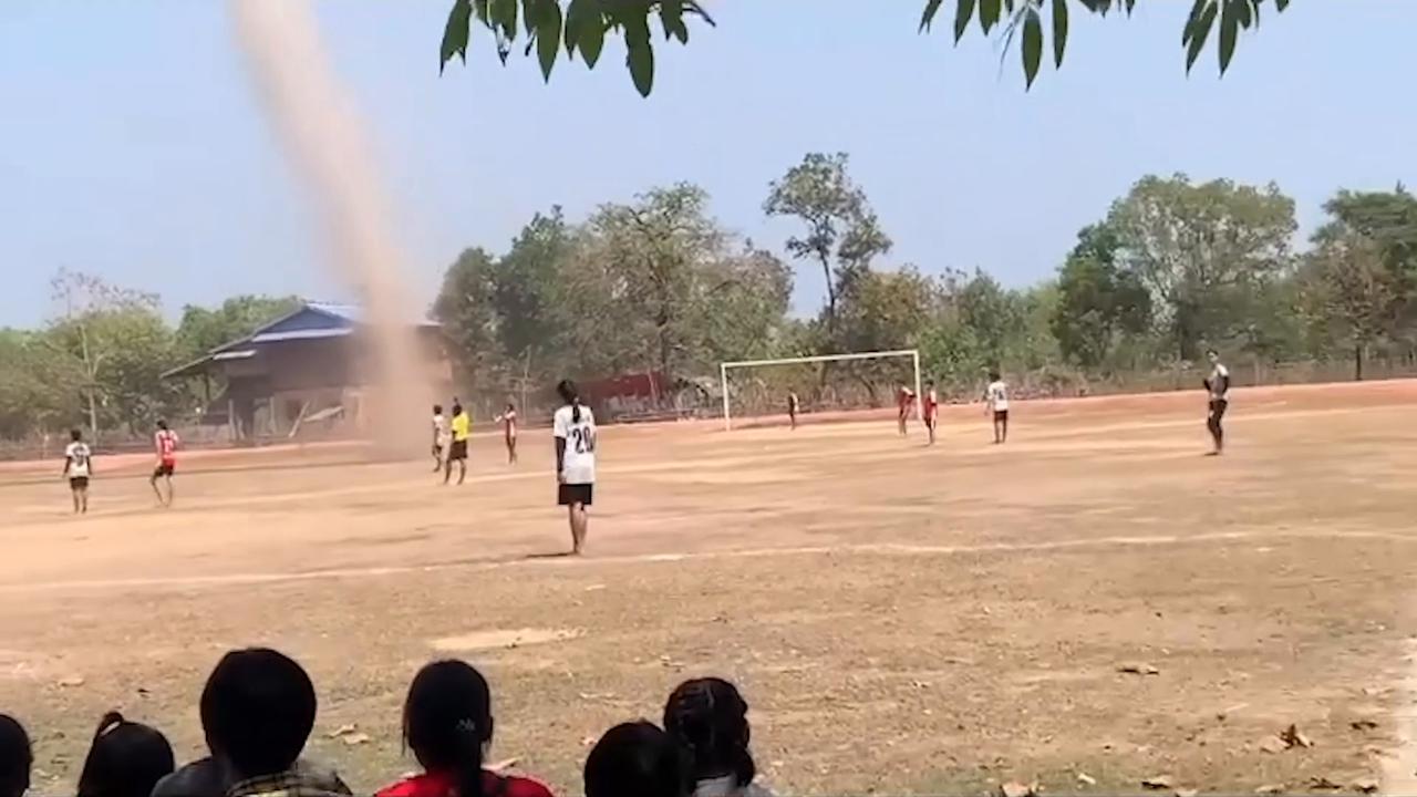 Huge dust devil tornado tears through pitch during football match
