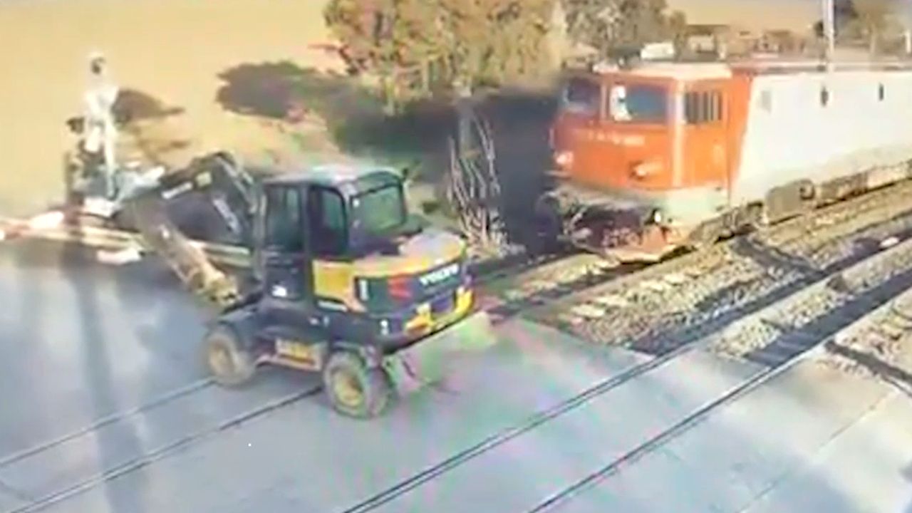 Shocking moment train plows through loader stuck on tracks