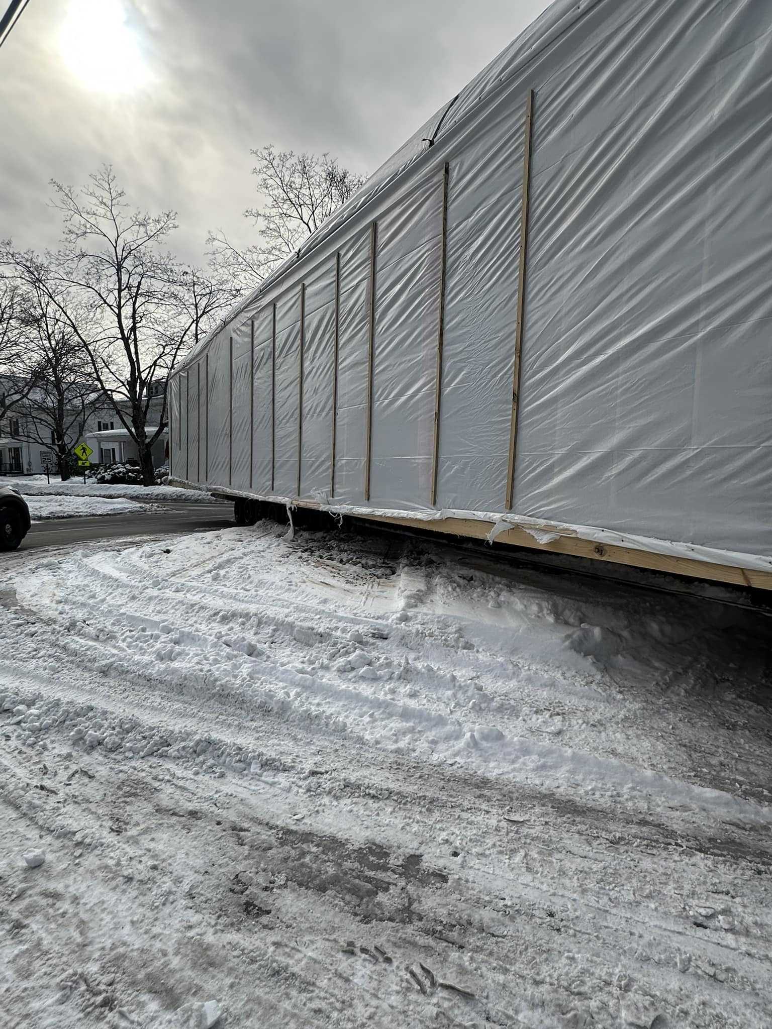 Tractor trailer hauling building gets stuck, blocks Maine rotary