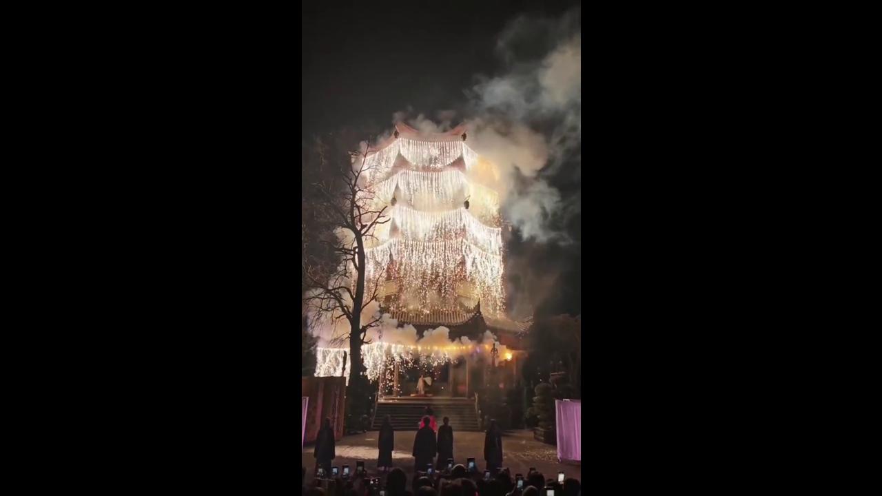 Stunning cold-fireworks waterfall lights up ancient building in China