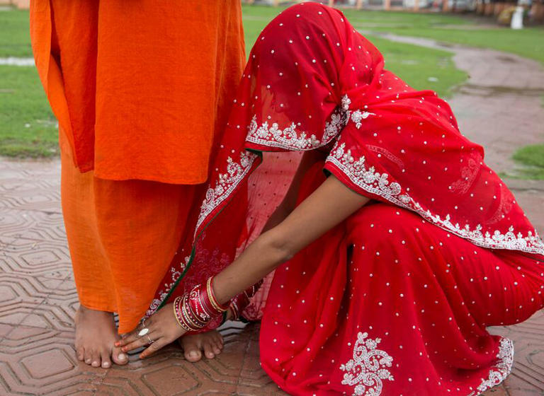 Kash Patel demonstrates the Indian custom of giving respect to elders